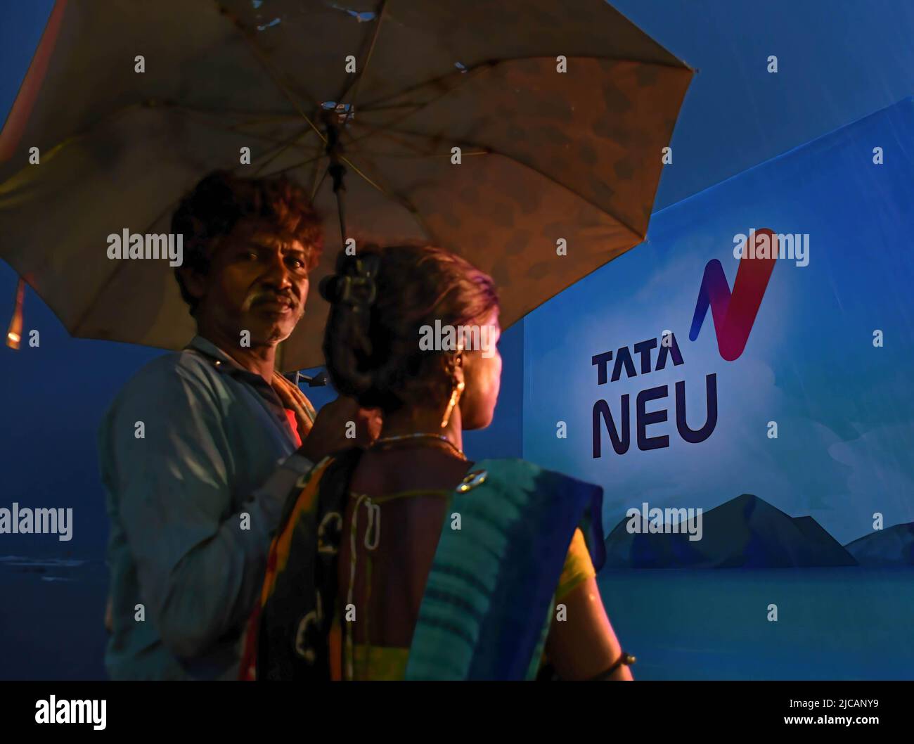 A man and a woman facing the logo of 'Tata Neu' in Mumbai. Promotional ...
