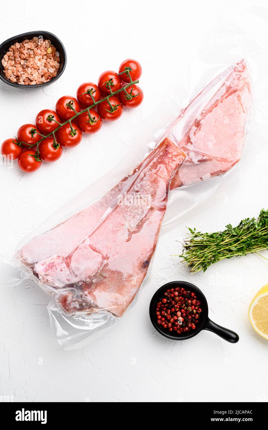Ocean Perch fish meat frozen pack , with herbs, on white stone table ...