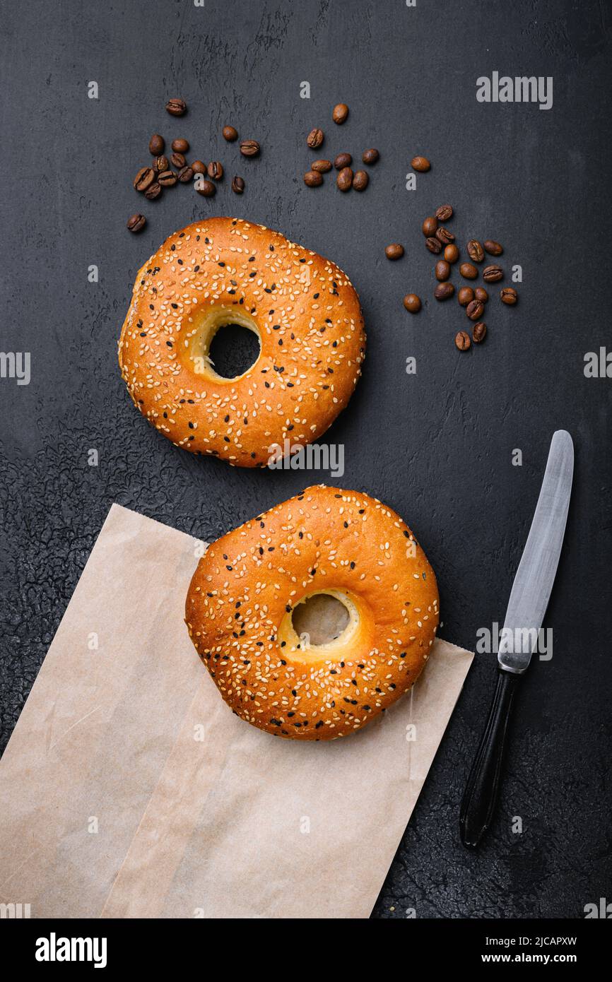 Fresh Sesame Bagel set, on black dark stone table background Stock ...