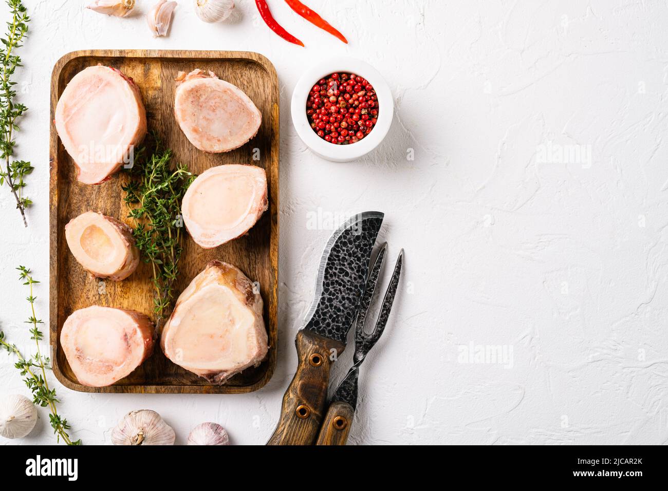 Ingredients for preparing beef broth, on white stone table background ...