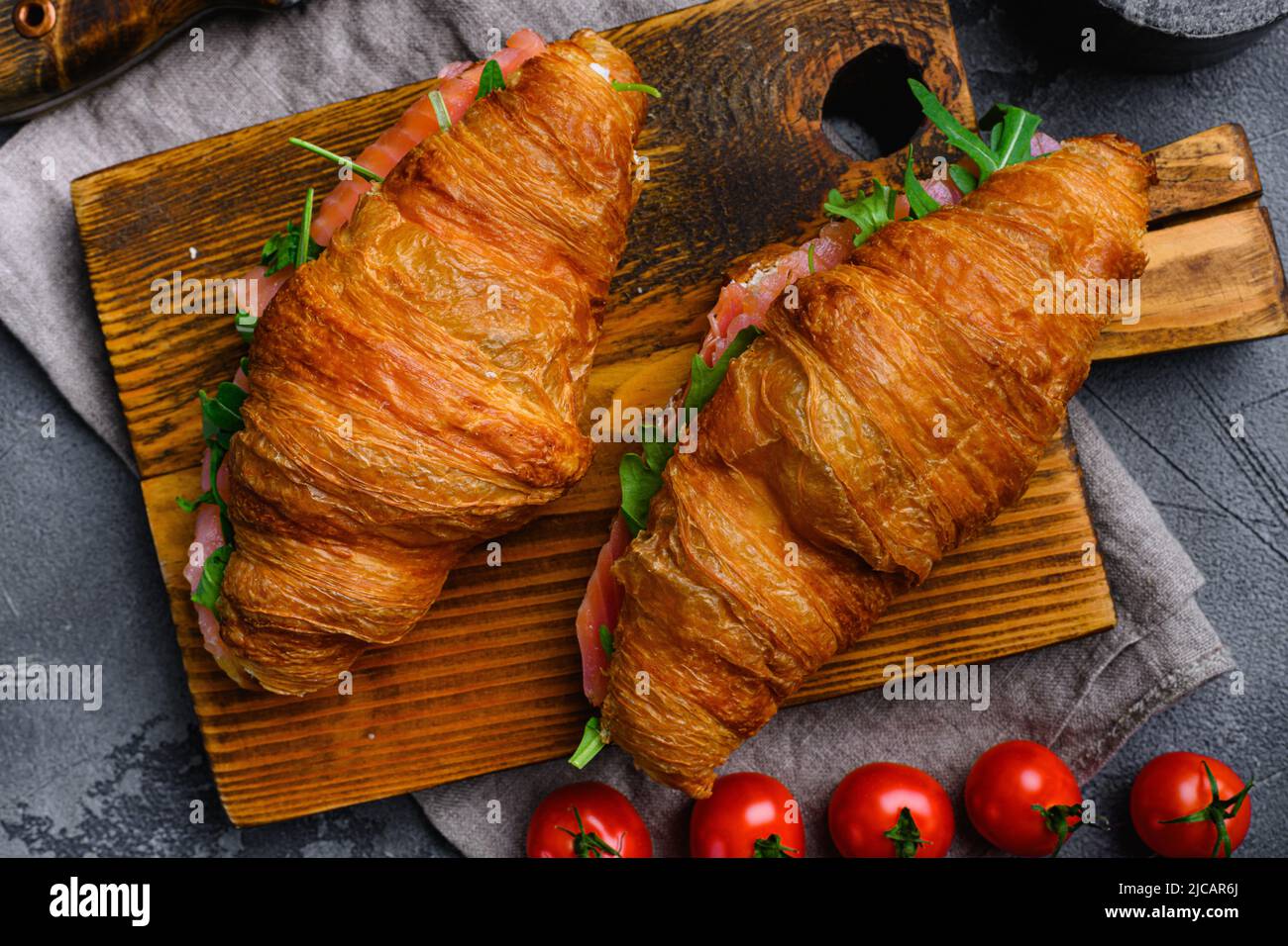 Croissant with salmon and cream cheese, on gray stone table background ...