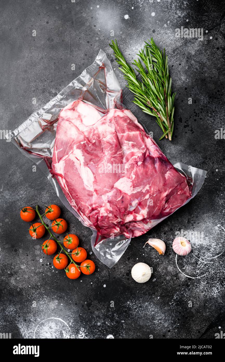 Fresh raw mutton shoulder meat, with ingredients and herbs, on black ...