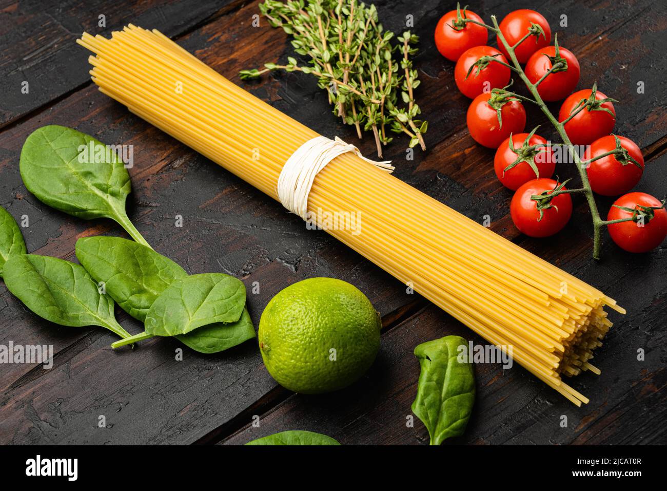 Original Italian raw dry pasta, on old dark wooden table background ...