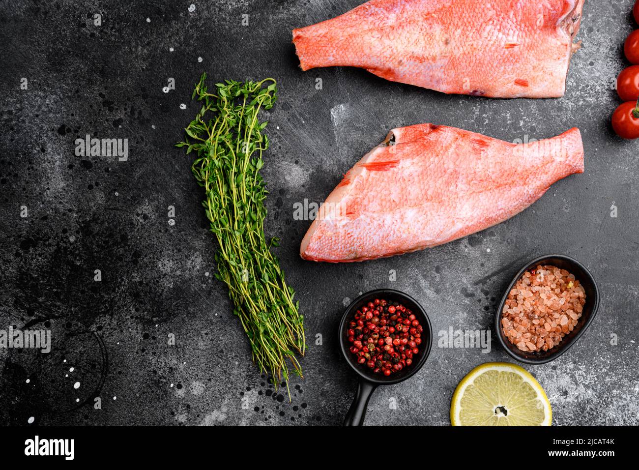 Fresh sea ocean red perch fish, on black dark stone table background ...