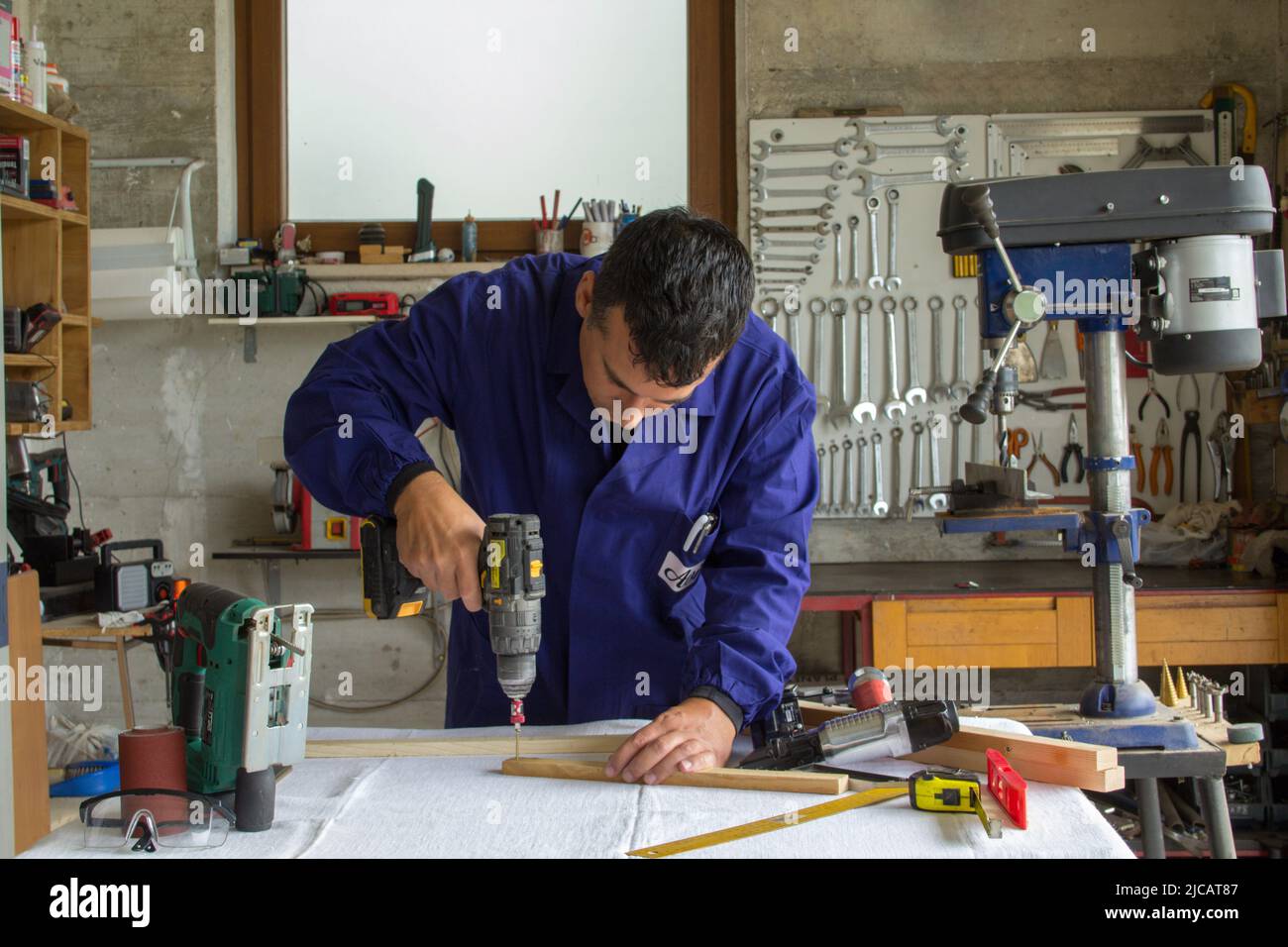 Picture of a handyman in his workshop restoring furniture by fixing ...