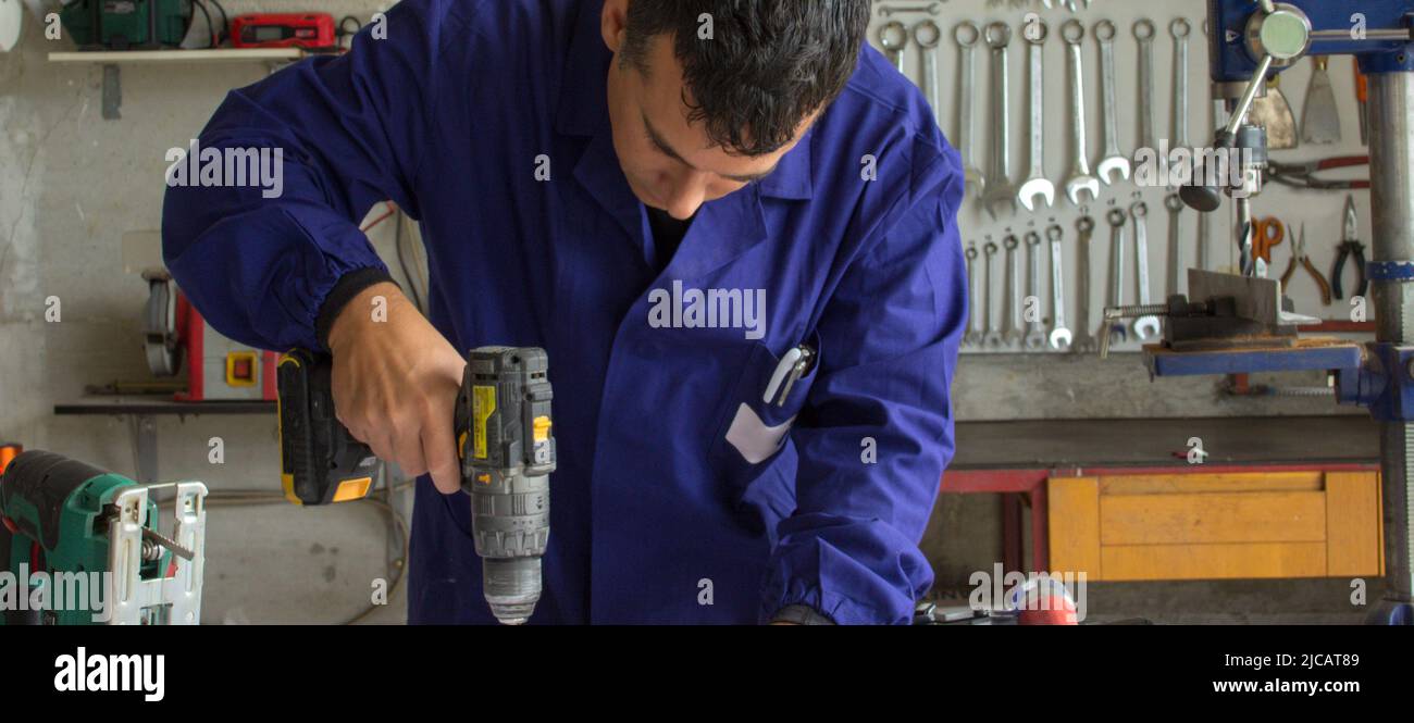 Picture of a handyman in his workshop restoring furniture by fixing ...