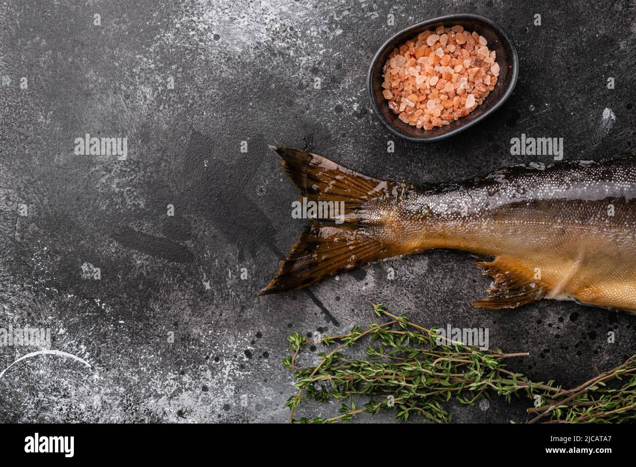 Smoked whole salmon, on black dark stone table background, top view ...