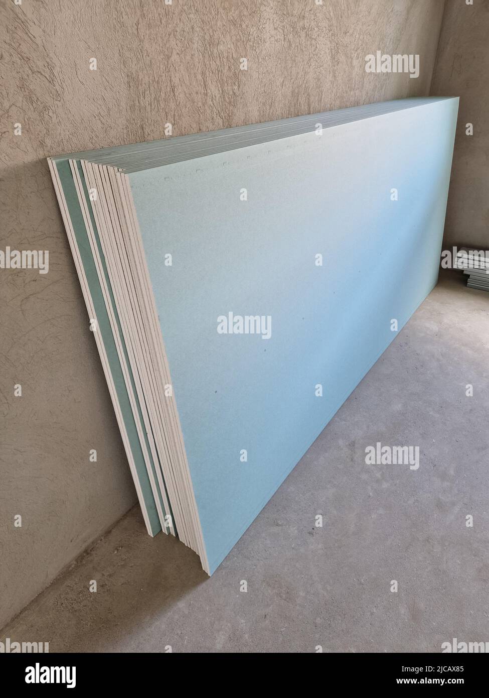 Drywall sheets for house ceilings stacked for mounting in construction ...