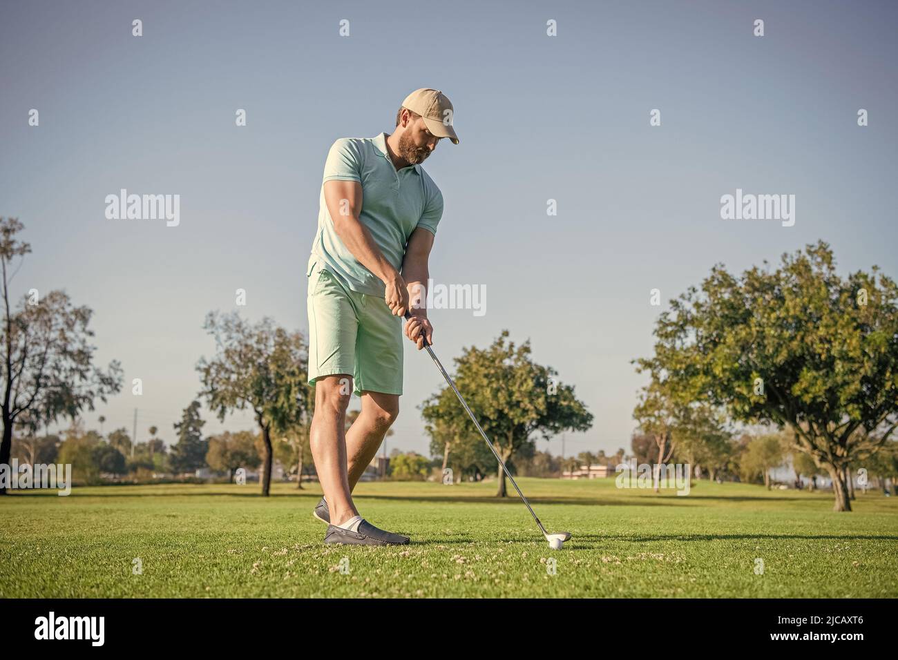 portrait of golfer in cap with golf club. people lifestyle. energetic ...