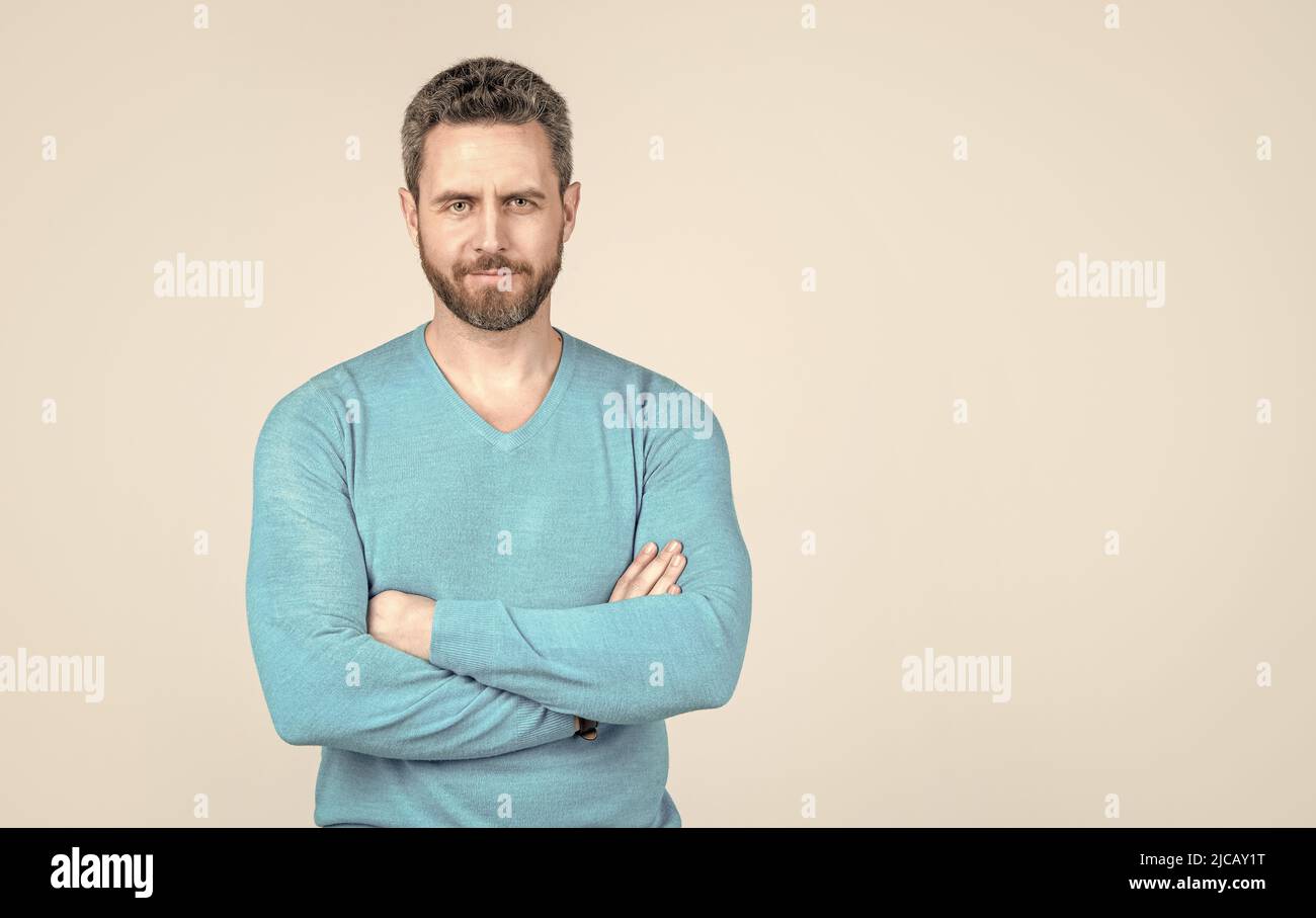 handsome man in casual wear has grizzled hair. successful man on grey ...