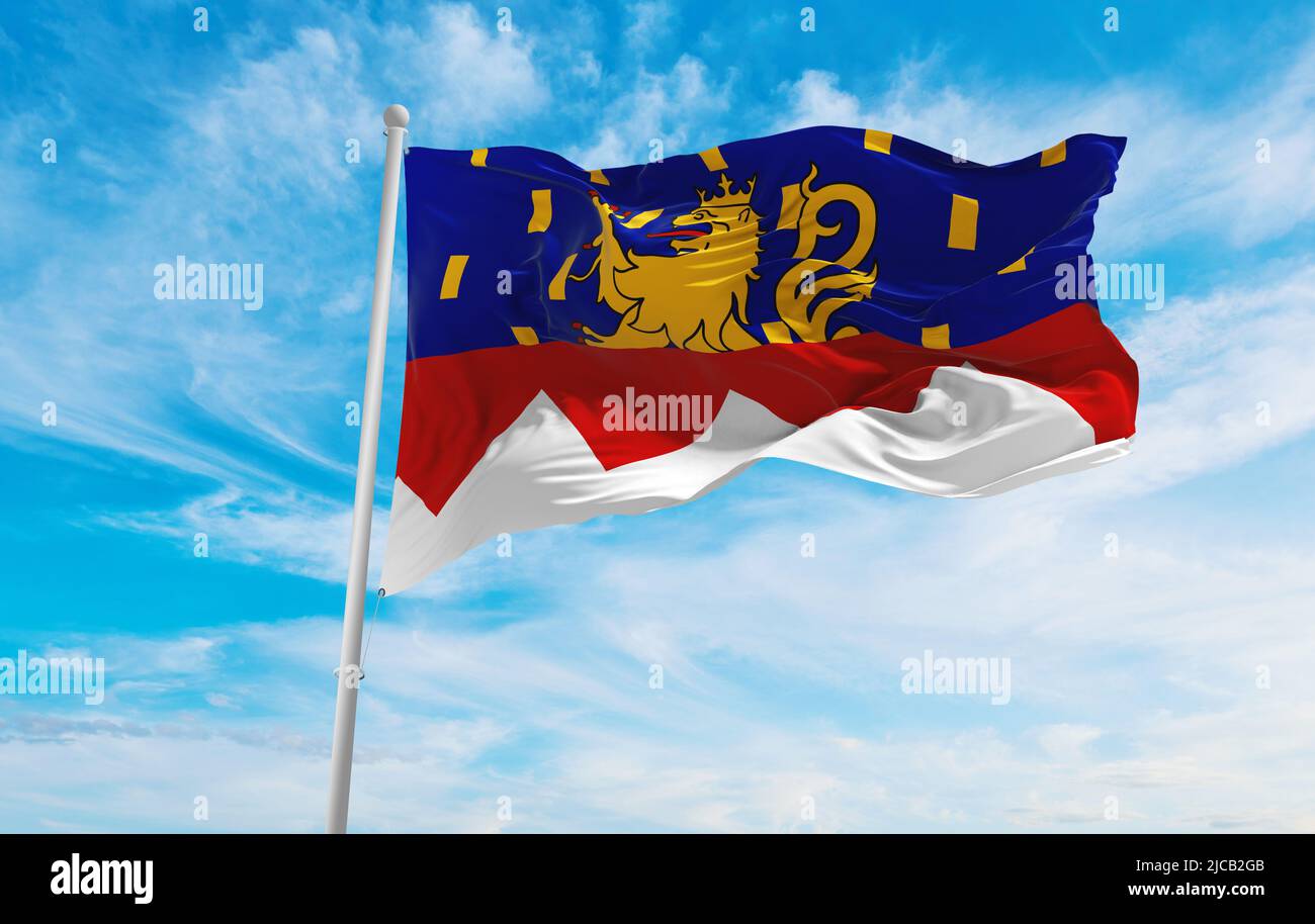 flag of Jura, France at cloudy sky background on sunset, panoramic view ...