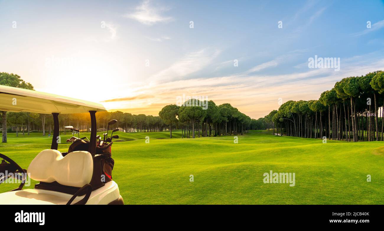 Golf cart on beautiful golf course at sunset Stock Photo - Alamy