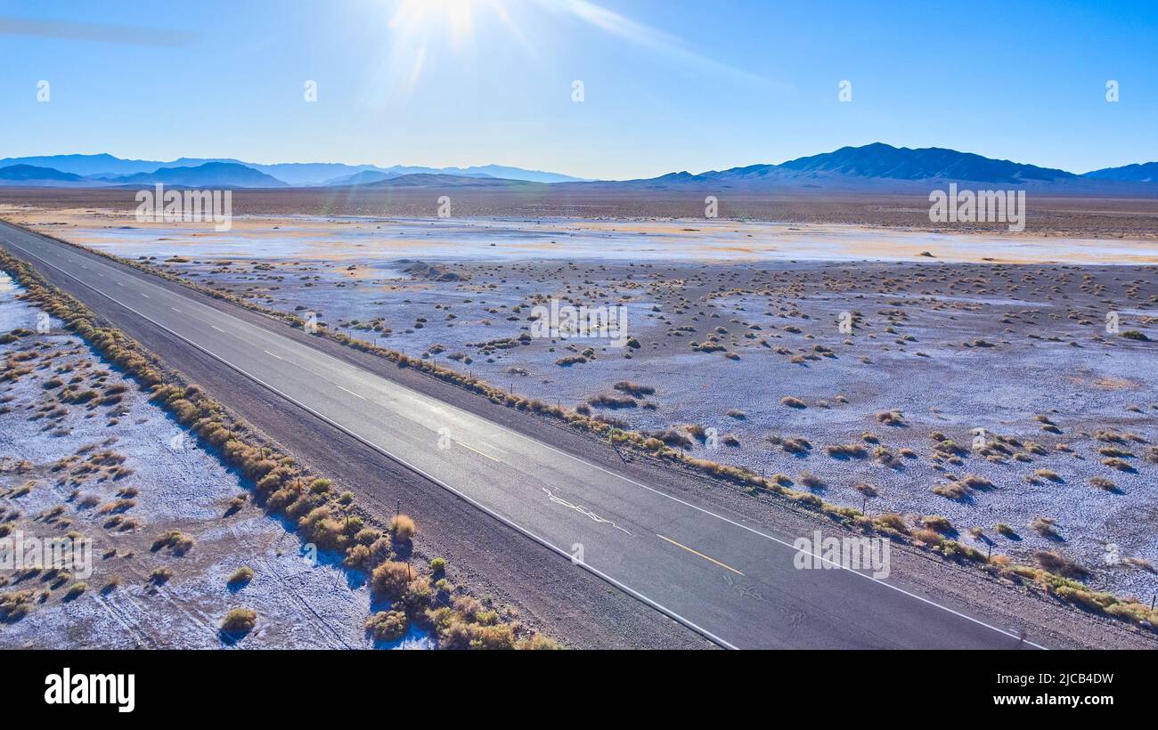 Tourist highway road through flat desert plains with mountains Stock ...