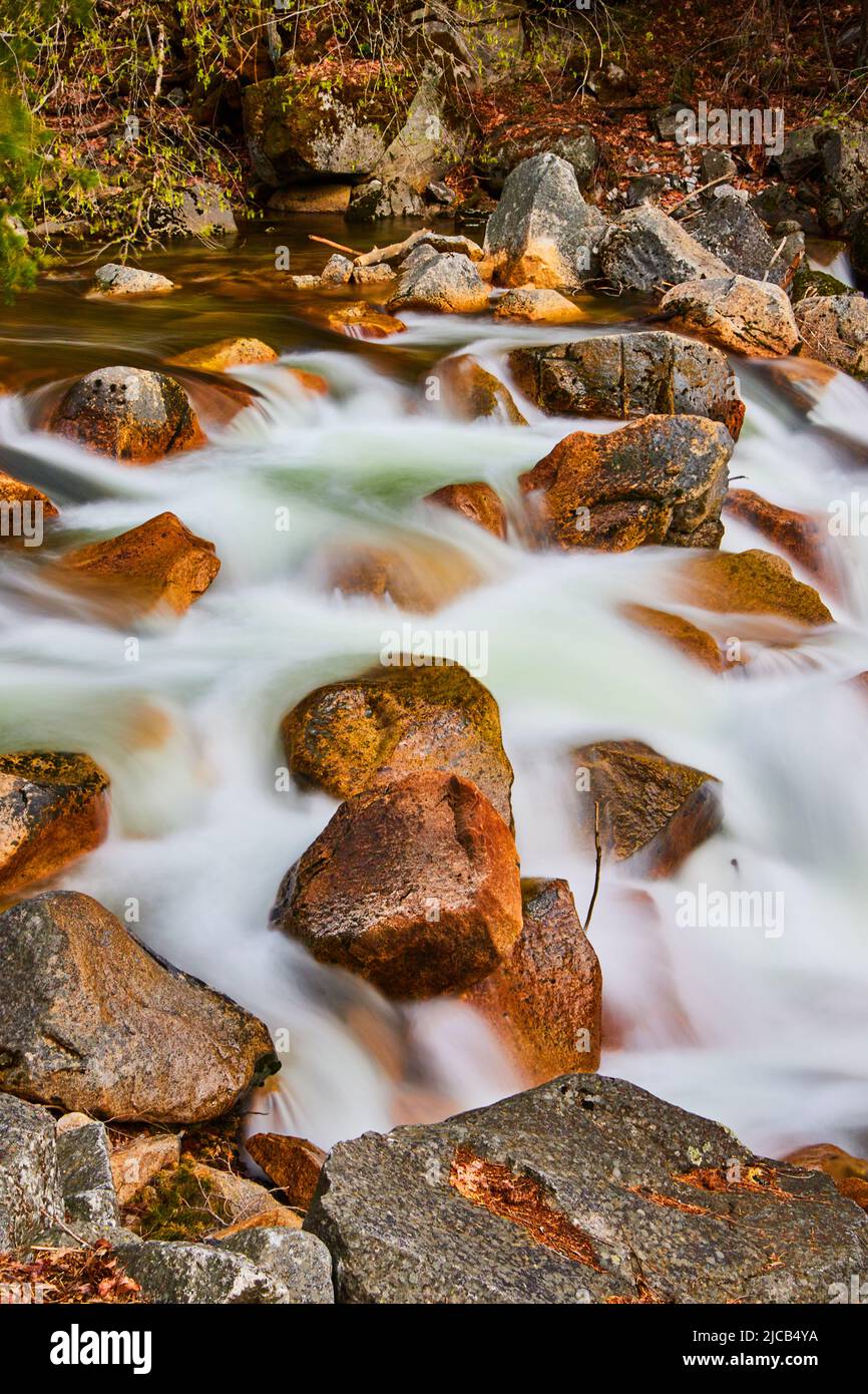 Rocks in river with water cascading over Stock Photo - Alamy
