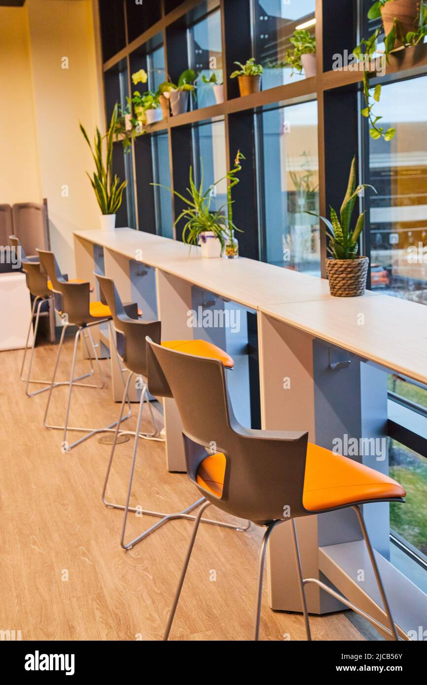 Modern coworking office space with desks by windows Stock Photo - Alamy