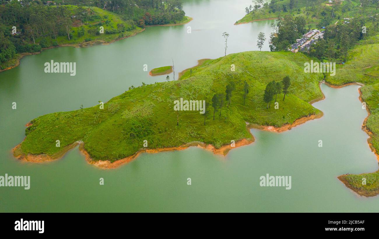 Top view of Lake among mountains and hills with tea plantations ...