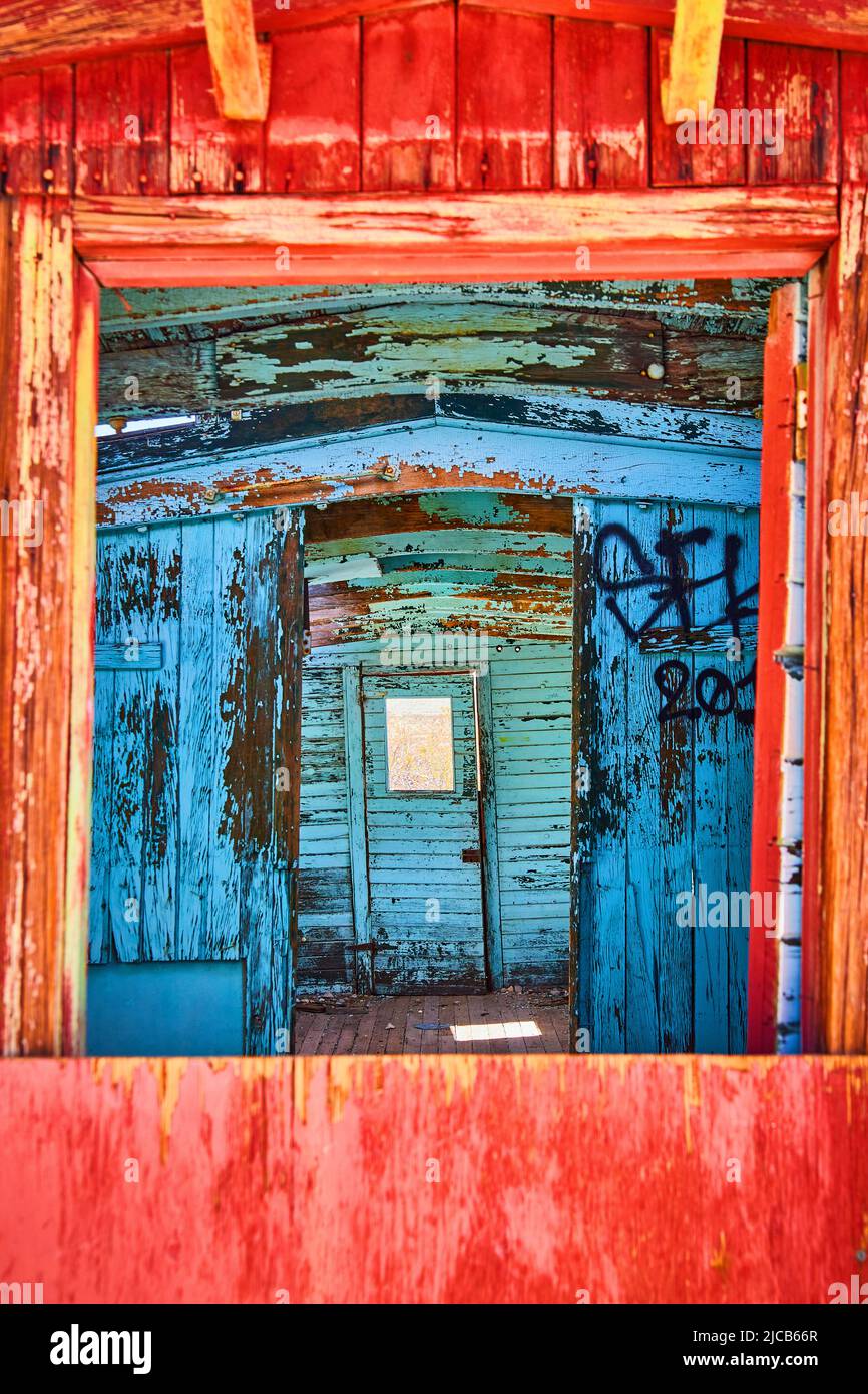 Layers of colorful carts inside abandoned train in desert with red and ...