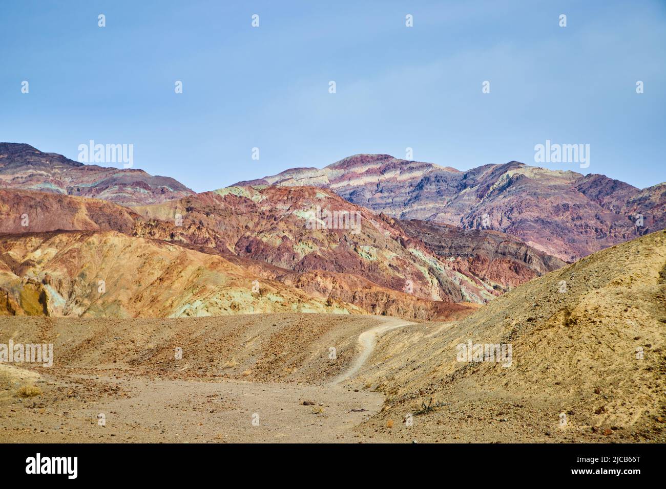 Path into Death Valley desert mountains with colorful patches Stock ...