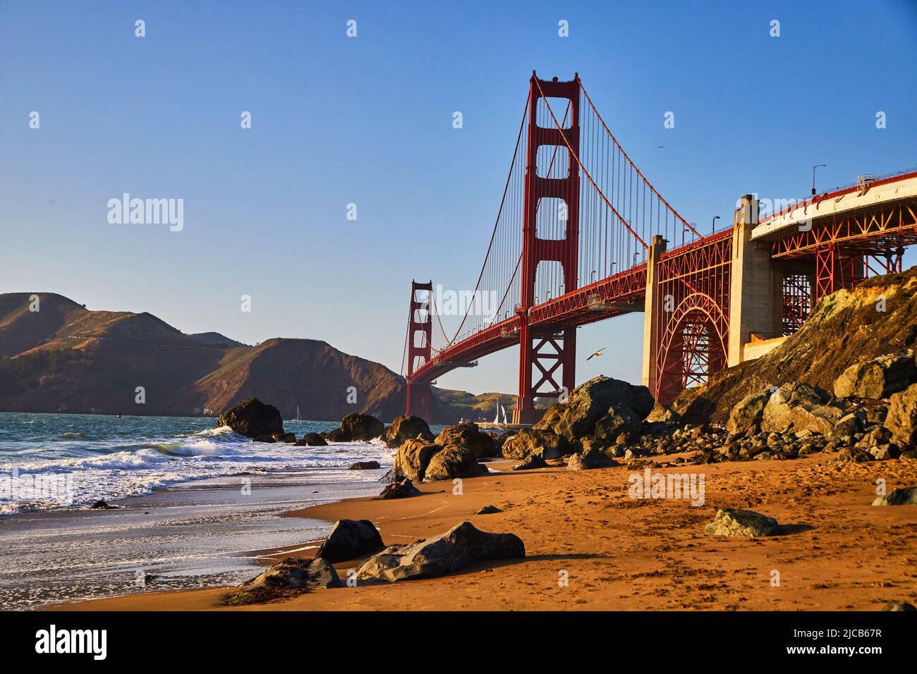 Sunset approaches Golden Gate Bridge from sandy beaches Stock Photo - Alamy