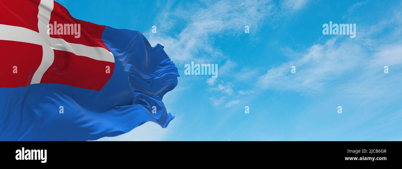 official flag of Danish blue ensign , Denmark at cloudy sky background ...