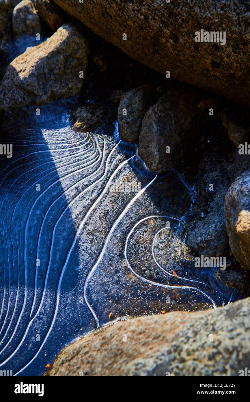 Rocks with wavy frozen ice layers in between Stock Photo - Alamy
