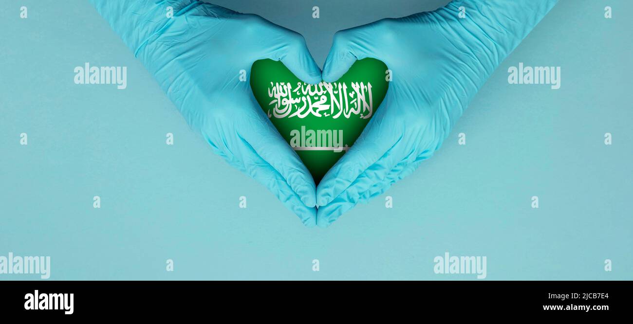 Doctors hands wearing blue surgical gloves making hear shape symbol ...