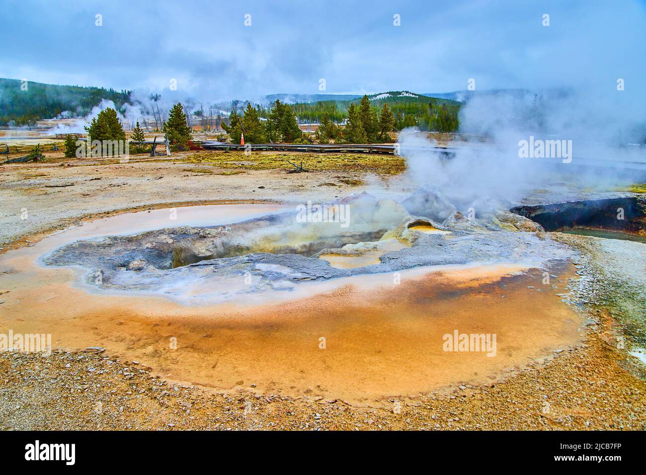 Steamy alkaline pools at Yellowstone in winter Stock Photo - Alamy
