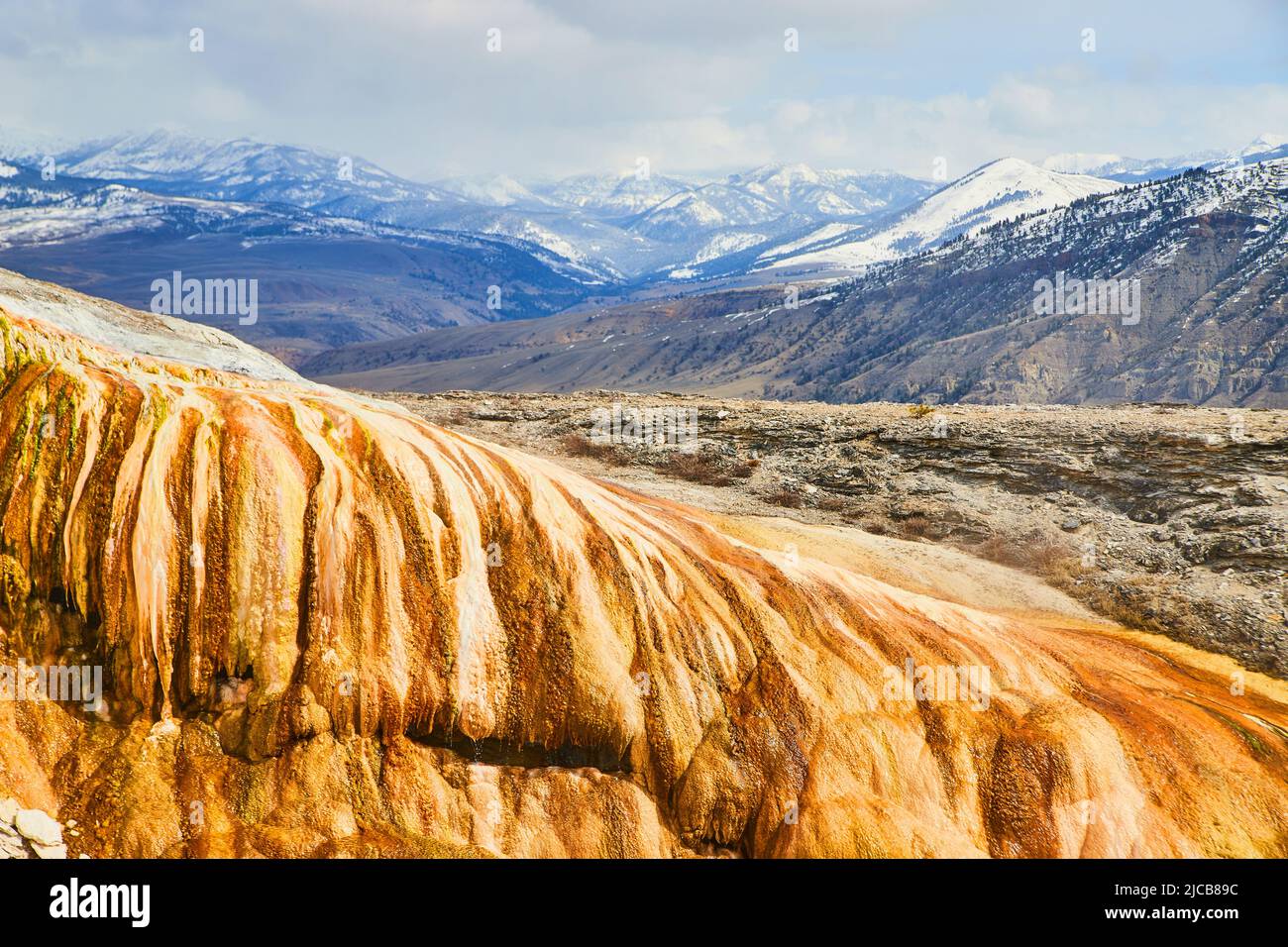 Snowy mountains with warm and colorful mounds at Yellowstone Stock ...