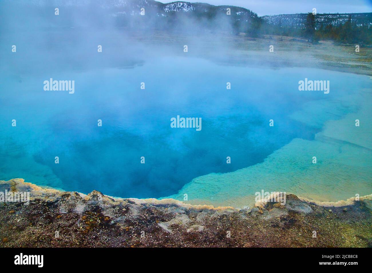 Sulfur steam rises off large deep blue pools in Yellowstone basin Stock ...