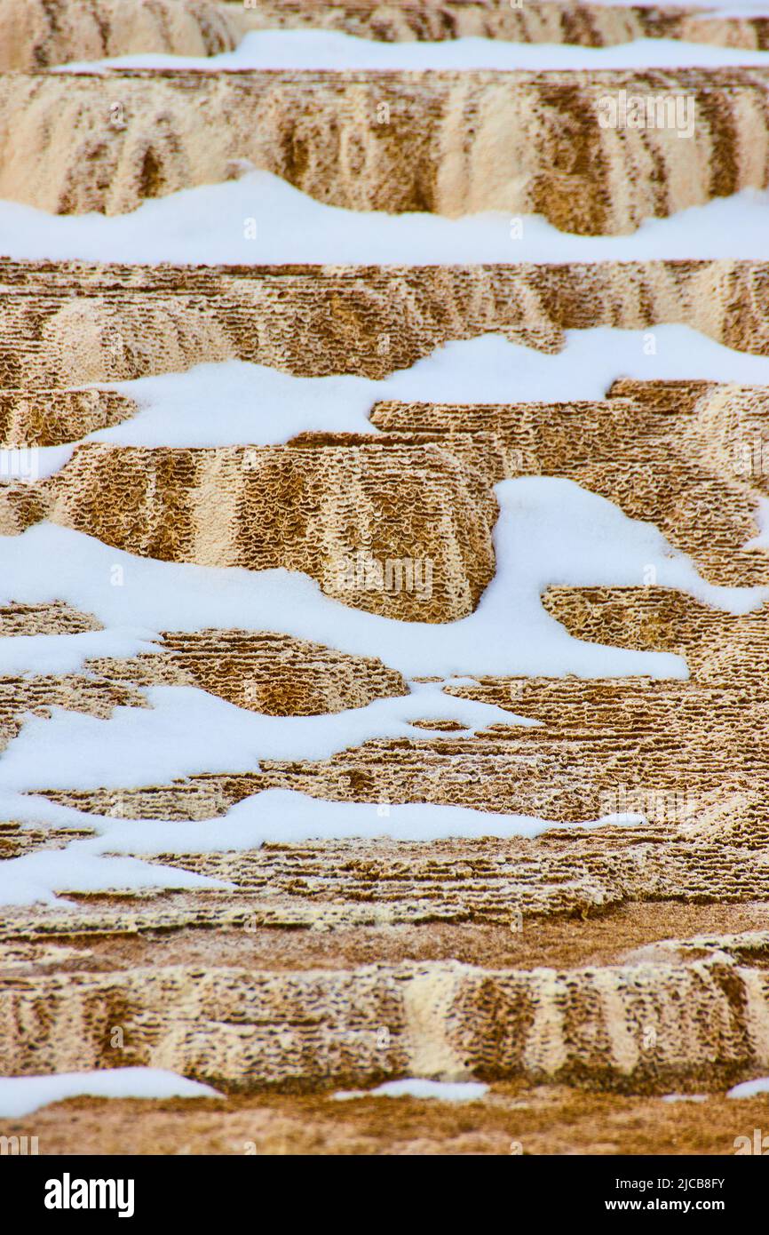 Snow covering terrace layers in detail at Yellowstone hot springs Stock ...