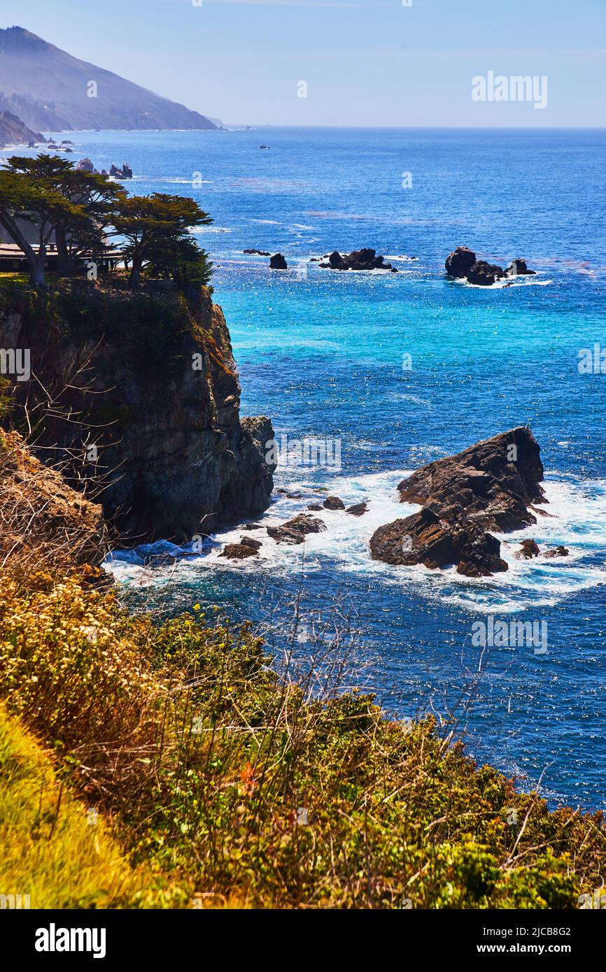 Stunning west coast ocean view with rocky cliffs and vibrant blue water ...