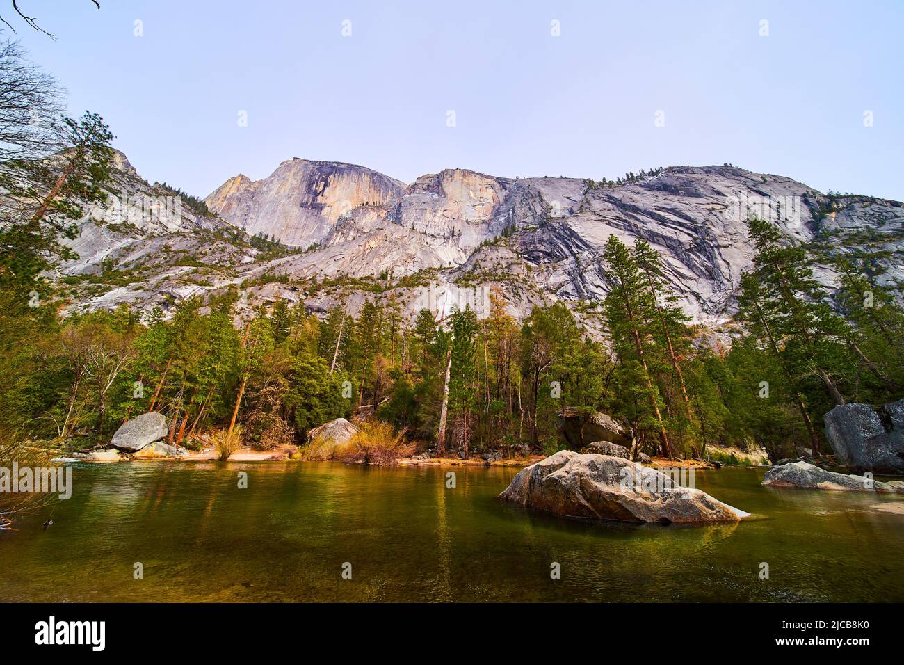Stunning cliffs of Half Dome by lake at Yosemite National Park Stock ...