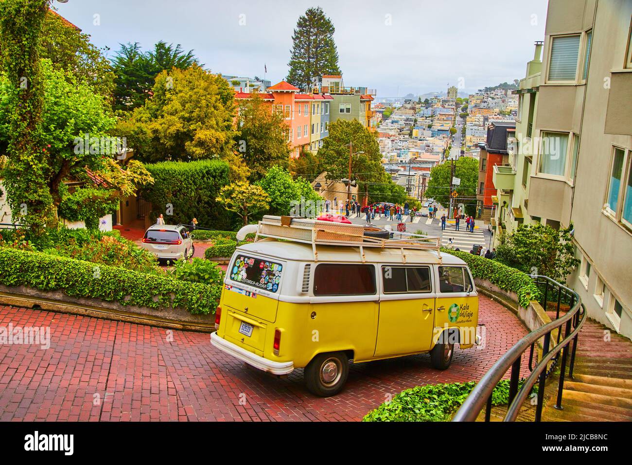 Red brick road curving down with yellow and white Volkswagen bus Stock ...