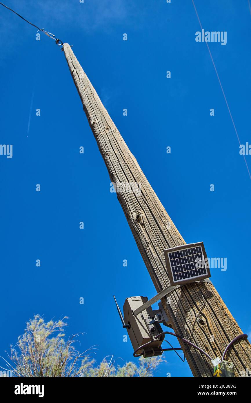 Looking up telephone pole with camera and solar panel Stock Photo - Alamy