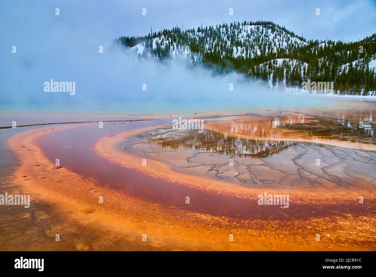 Layers of red and orange waters from spring in Yellowstone winter Stock ...