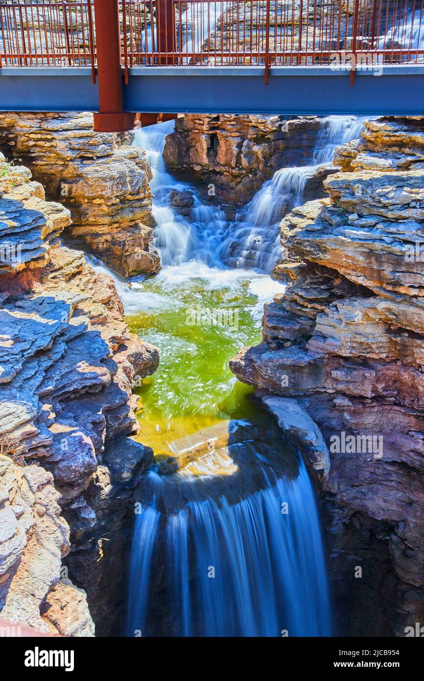 Part of bridge seen over stunning waterfalls in rocks pouring into ...