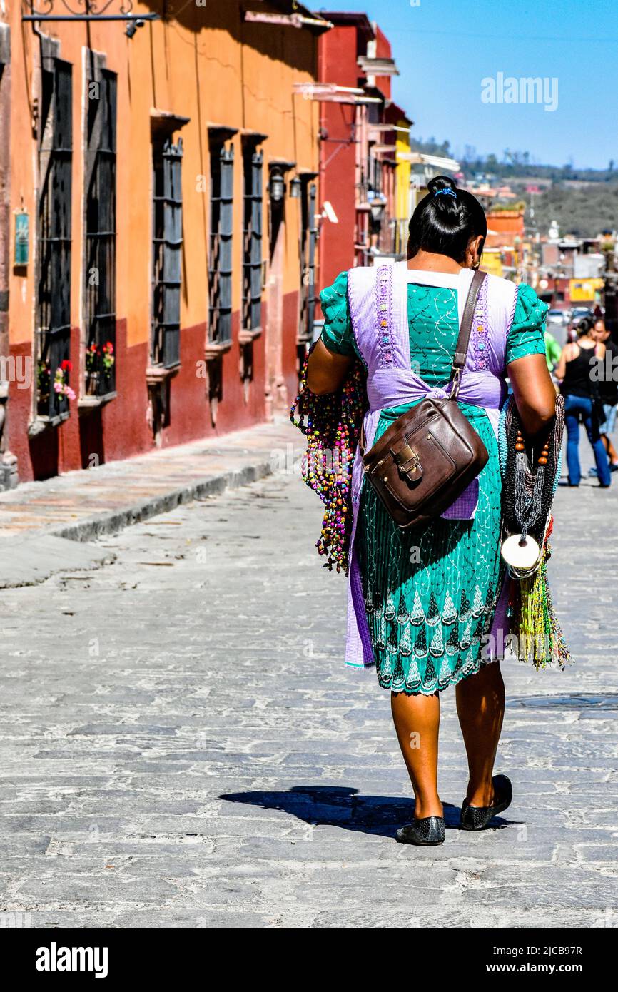 Local artisan wearing traditional clothes walks the cobblestone streets ...