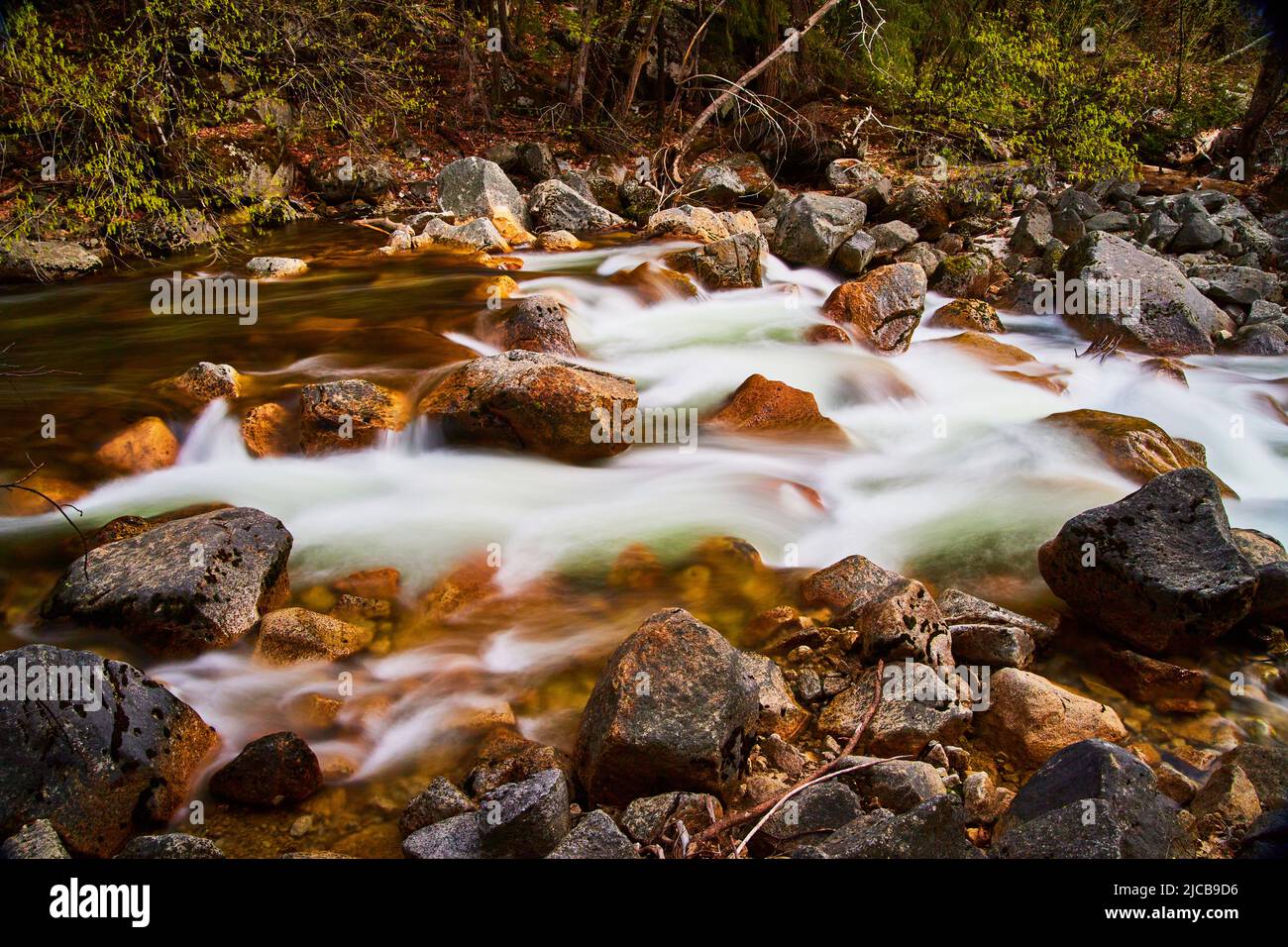 Side profile of river with water cascading over rocks Stock Photo - Alamy
