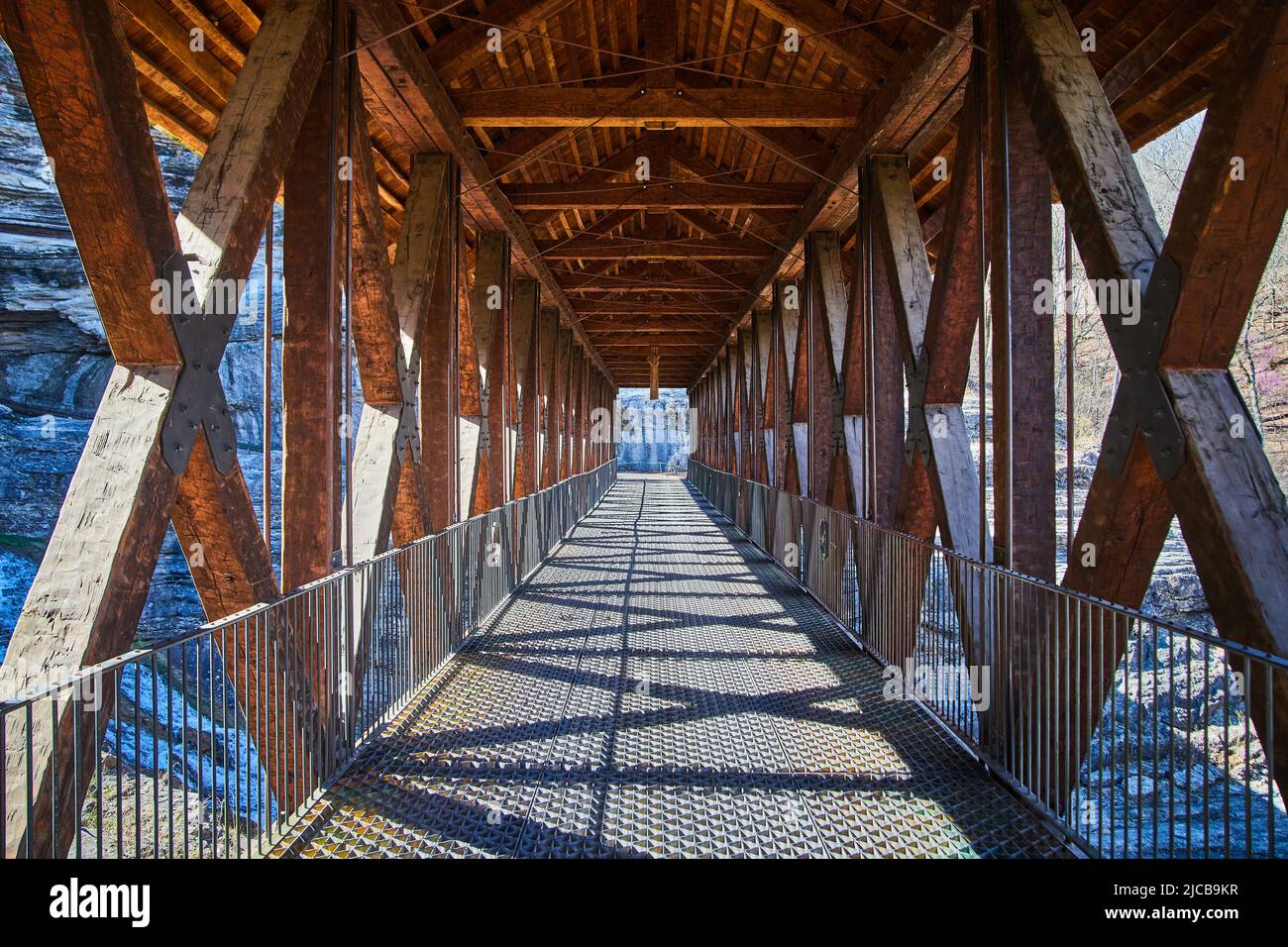 Looking down long walking bridge of wood and metal Stock Photo - Alamy