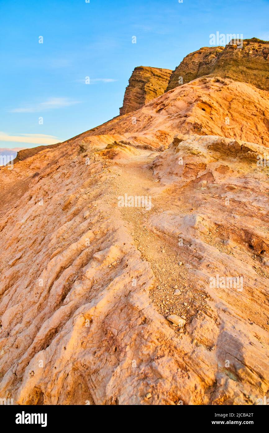 Narrow hiking path along top of red rocky desert mountain in Death ...
