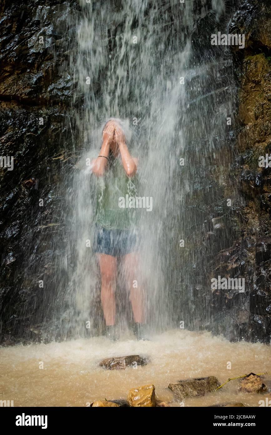 White Woman Covering her Eyes from the Water Falling in the Small ...