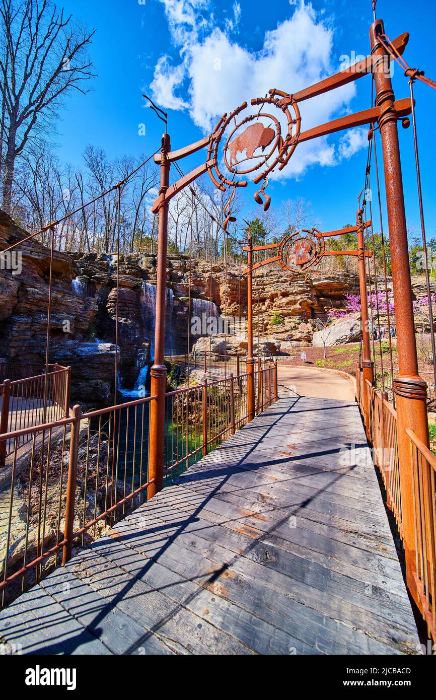Looking down short and artsy walking bridge in early spring leading to ...