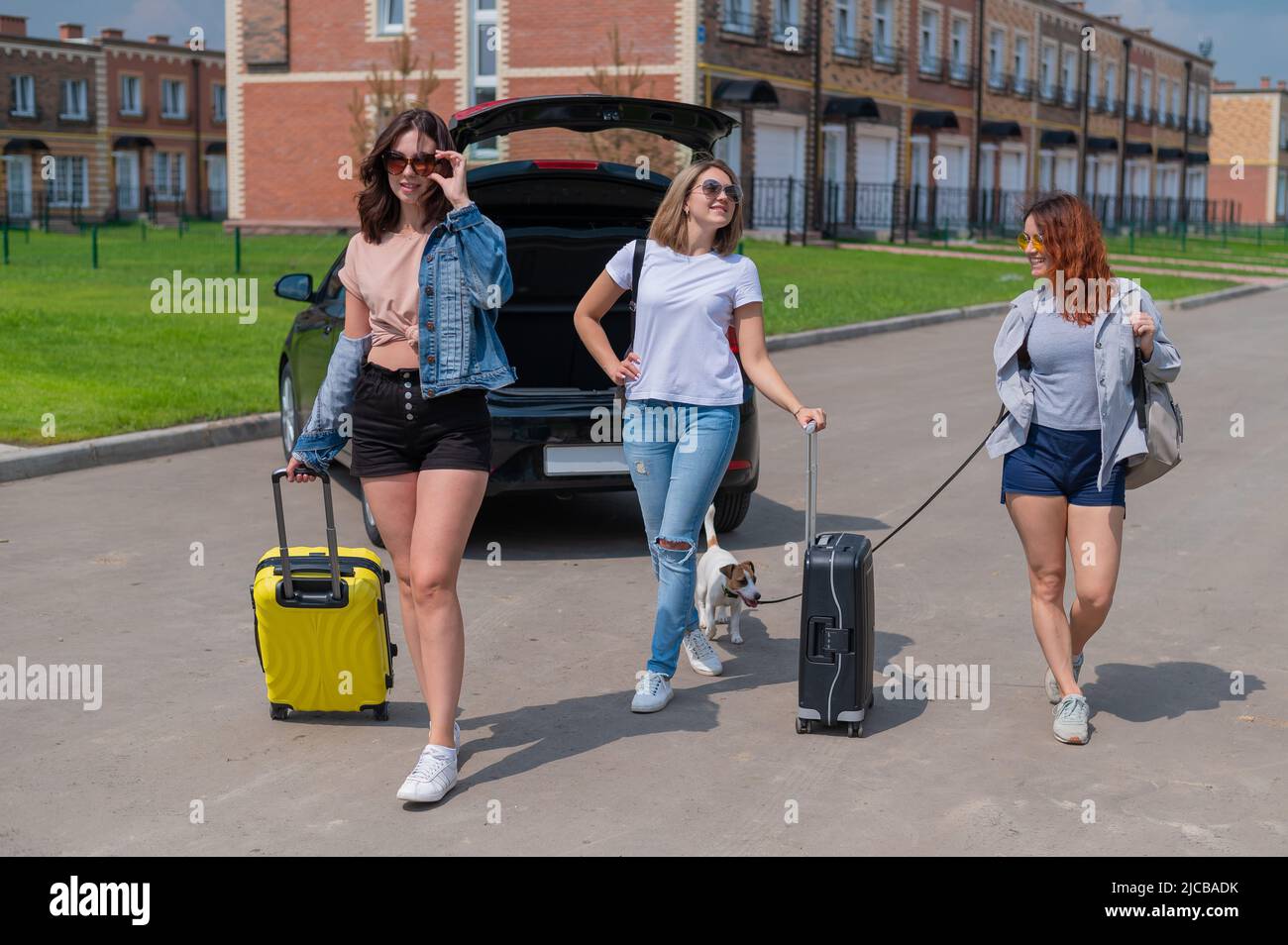 Three friends go on a trip by car Stock Photo - Alamy