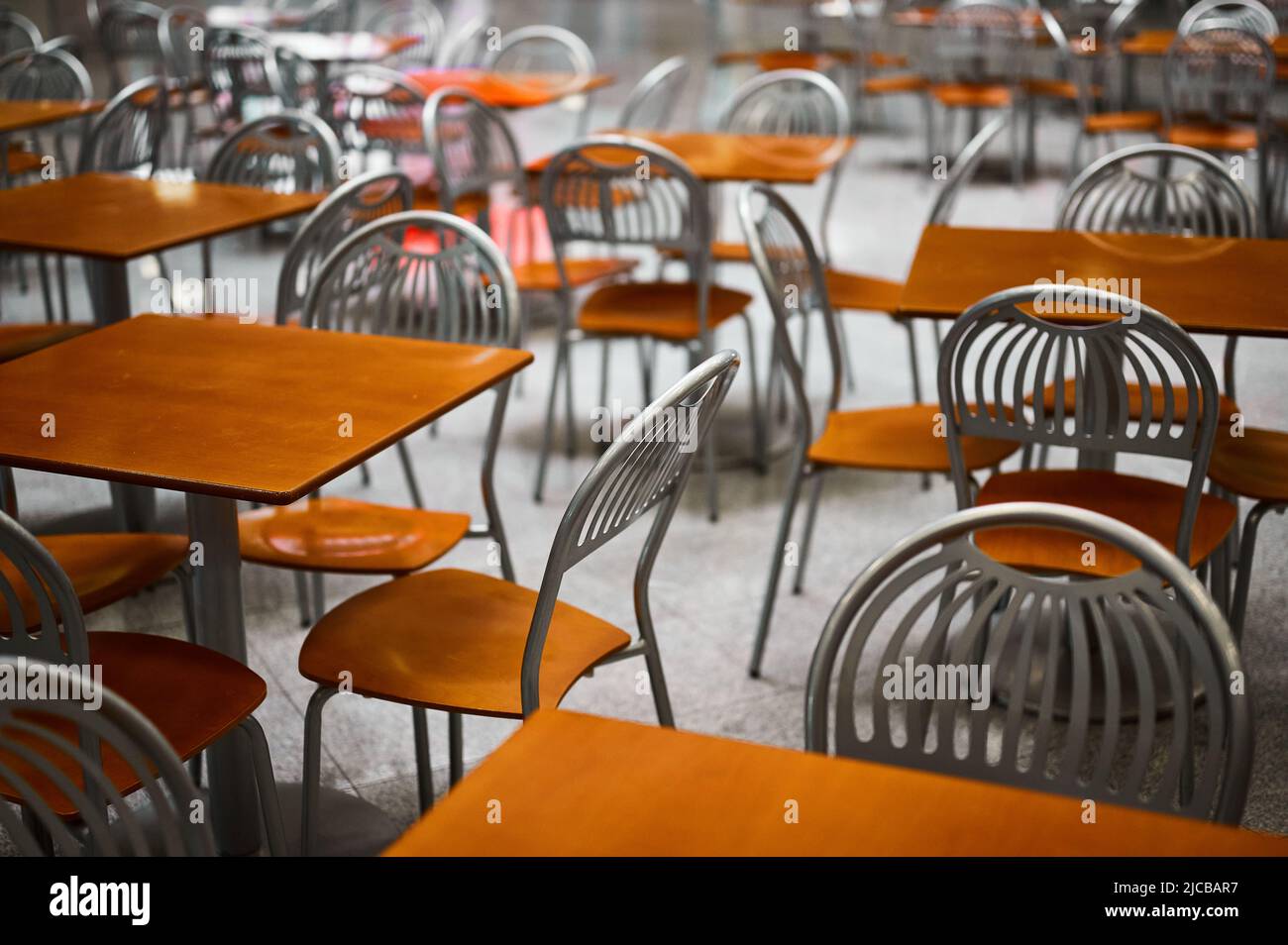 Wooden tables and chairs at large empty foodcourt in mall Stock Photo ...