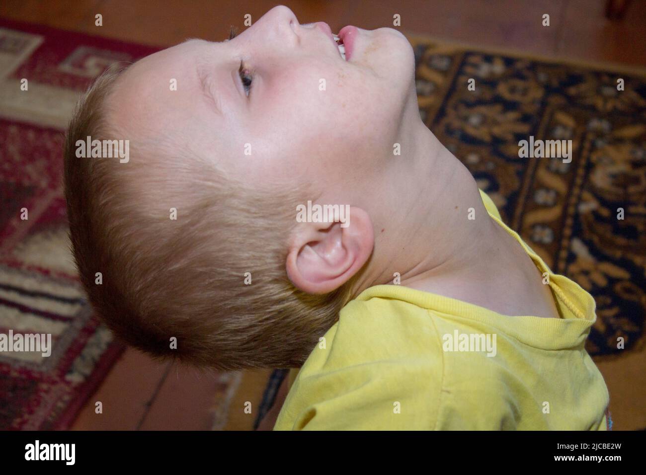 happy boy raised his head and looked up at the ceiling Stock Photo - Alamy