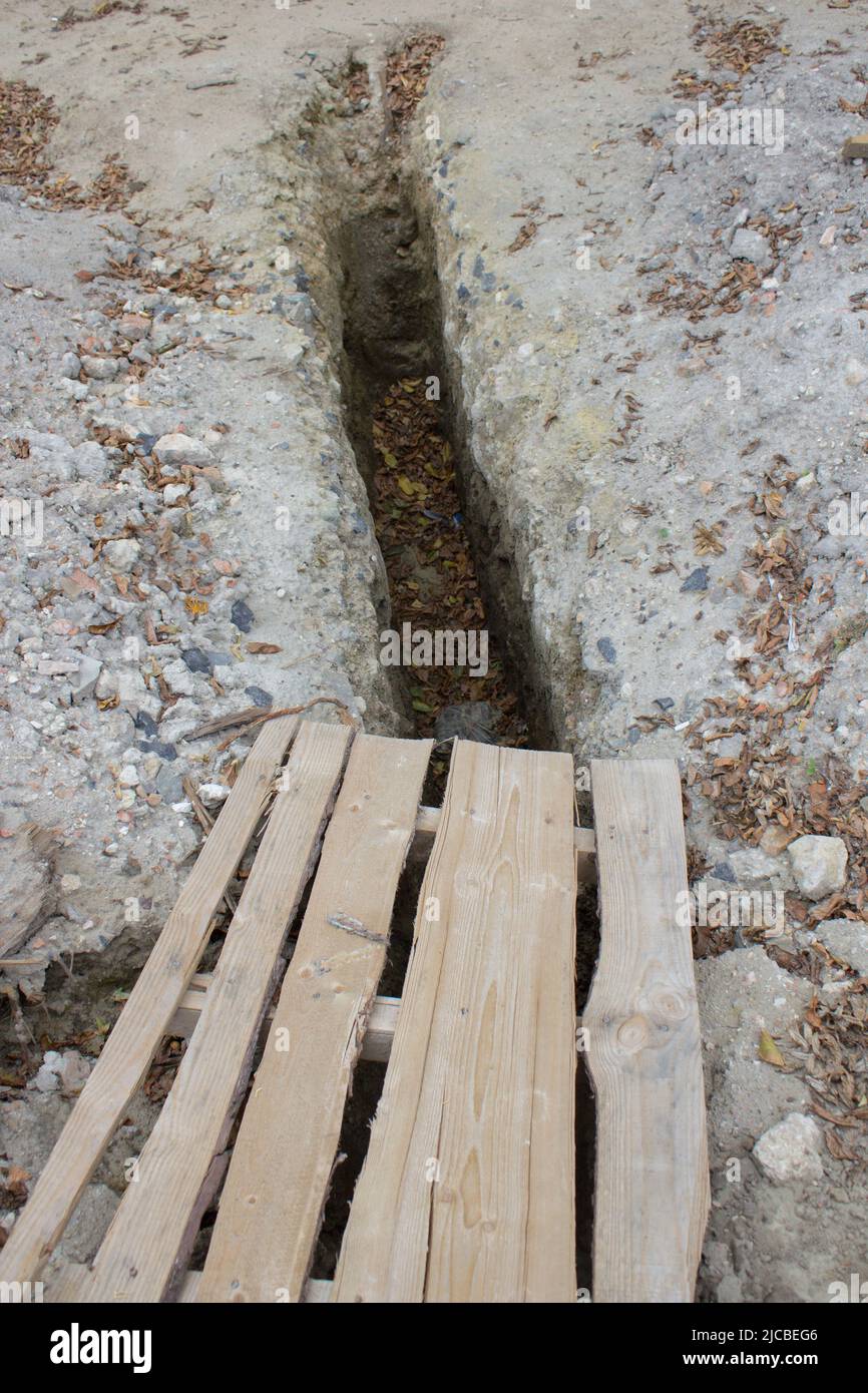 long pit dug on the road is dangerous Stock Photo - Alamy