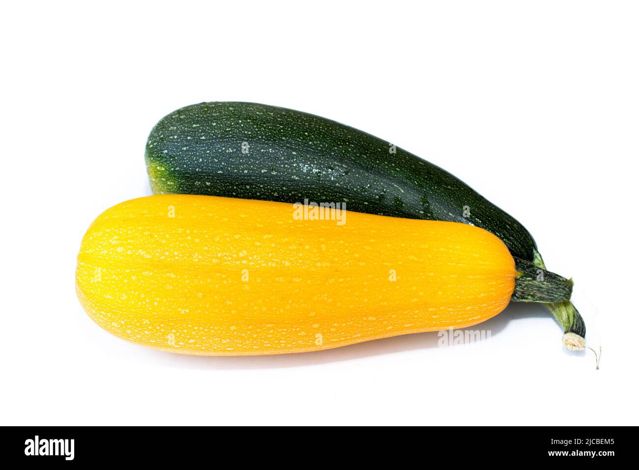 Two ripe zucchini on a white background green and yellow Stock Photo ...