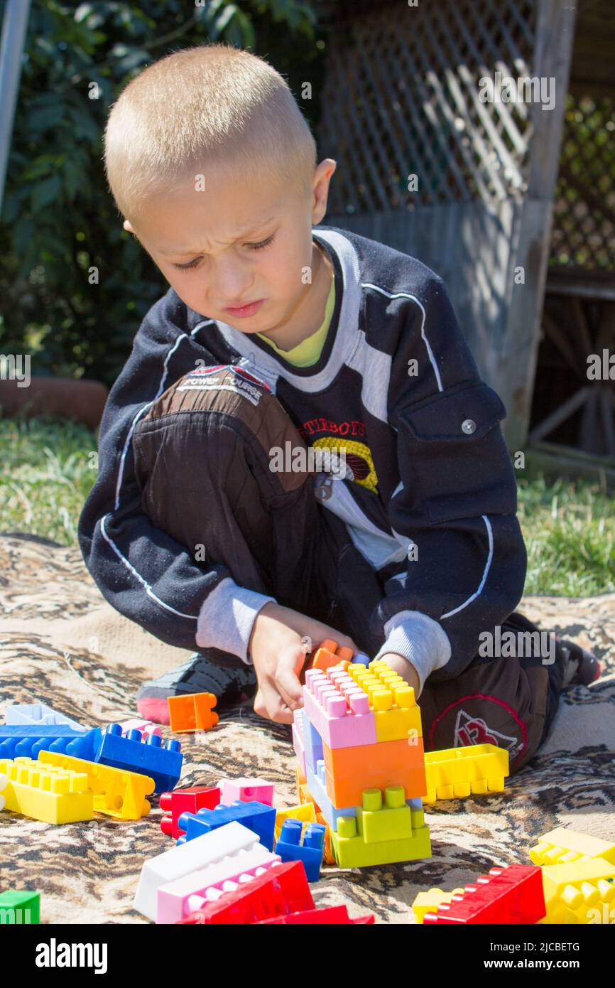 cute boy build from plastic blocks. Isolated on white background ...