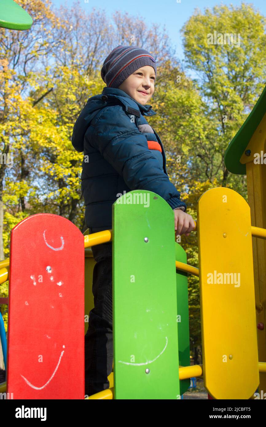 happy boy walking on children's swing joyful boy Stock Photo - Alamy