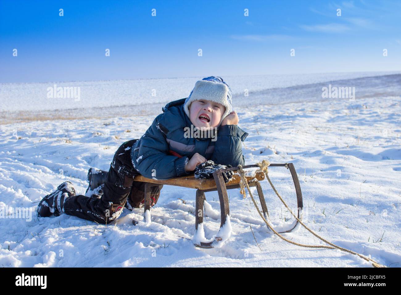 Boy on sled hi-res stock photography and images - Alamy